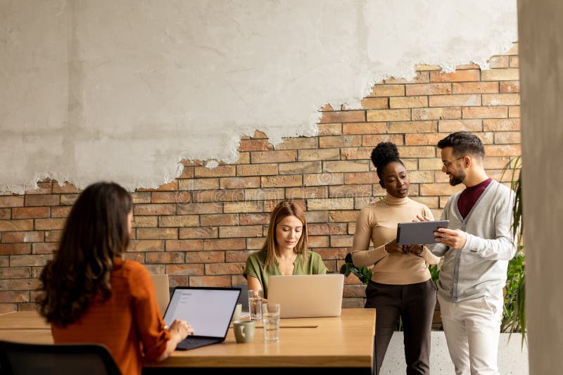 Young Multiethnic Startup Team Working in the Rustic Office Stock Photo ...