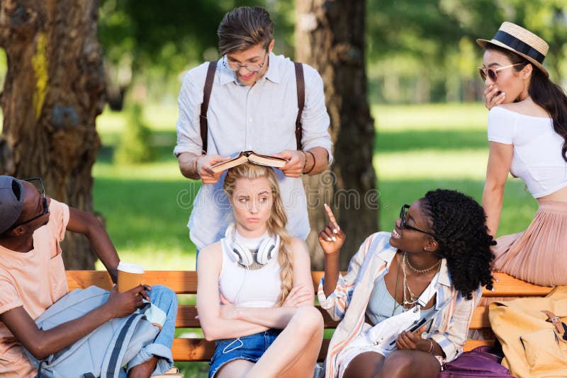 Multiethnic Students Having Fun while Studying Together on Bench in ...