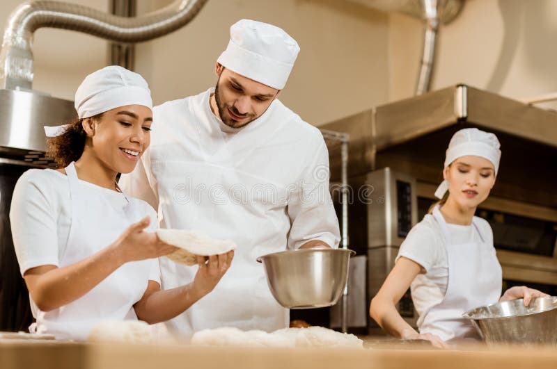 Young Multiethnic Team of Bakers Working Together Stock Photo - Image ... Young Multiethnic Team of Bakers Working Together Stock Photo - Image ...