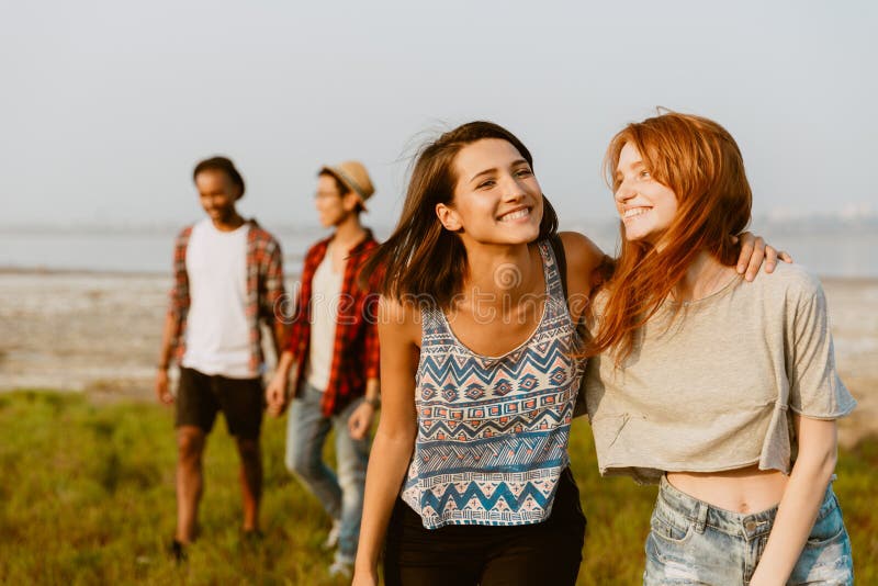 Young Multiracial Friends Hugging and Smiling Together Stock Photo ...