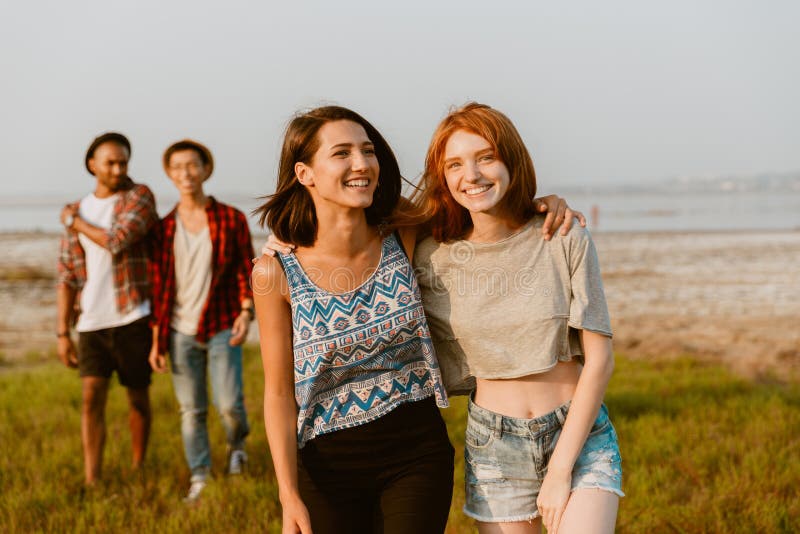 Young Multiracial Friends Hugging and Smiling Together Stock Photo ...