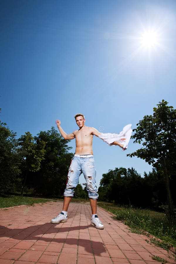 Young Muscular Athlete Taking His Shirt Off Stock Photo - Image of ...