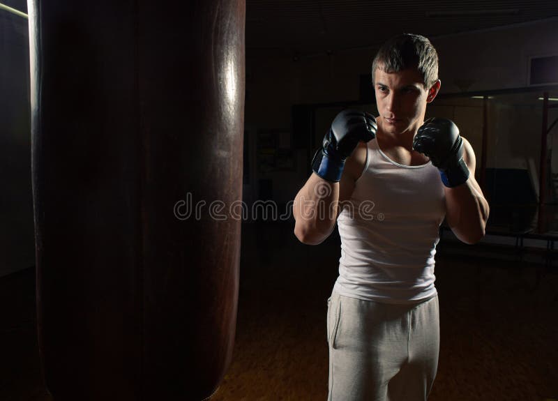 Young Muscular Man Boxer Workout with Punching Bag Stock Photo - Image ...