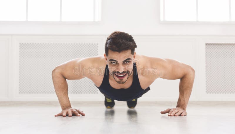 Young Muscular Man Pushing Ups in Studio Stock Photo - Image of ...