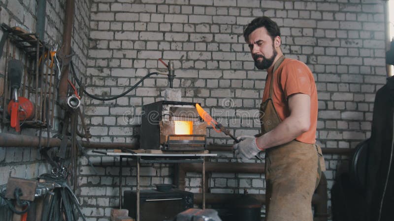 Young Muscular Man Working on a Blacksmith with Metal Stock Image ...