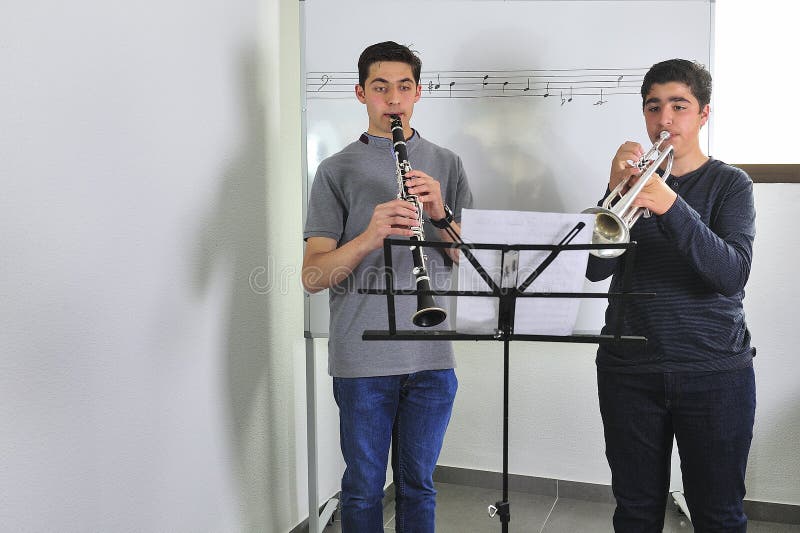 Young Music Students Study Sheet Music Lesson in the Classroom. Stock ...