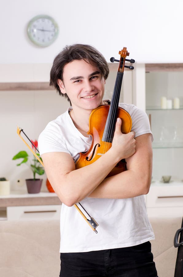 The Young Musician Man Practicing Playing Violin at Home Stock Photo ...