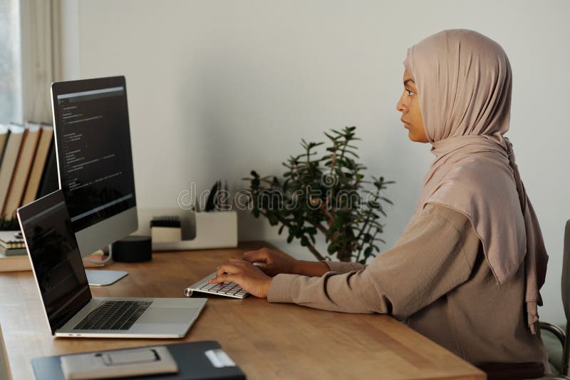 Young Muslim Businesswoman in Hijab Decoding Data on Computer Screen ...