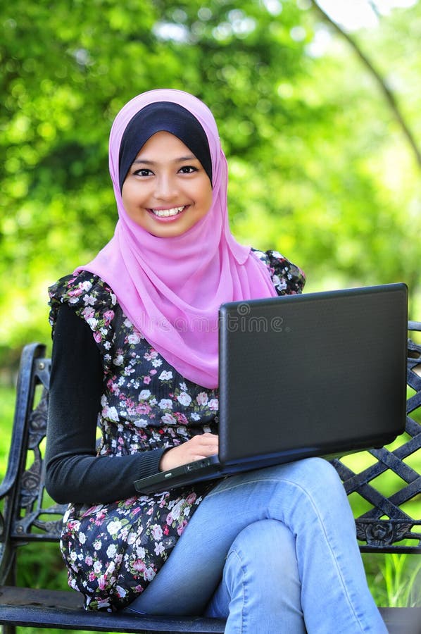 A Young Muslim Woman Reading a Book Stock Photo - Image of student ...