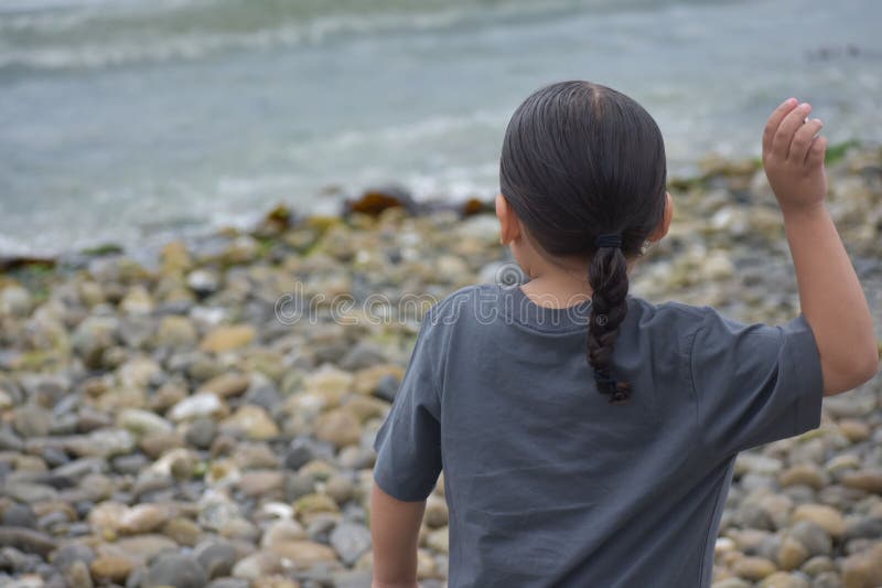 Young Native American Boy Playing at the Rocky Shoreline Stock Photo ...