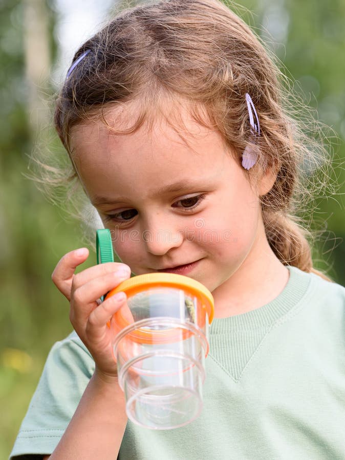 Young Nature Explorer Studying Grasshopper in Bug Viewer Jar Stock ...