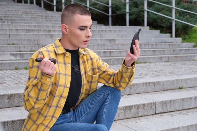 Young Non Binary Gender Person Applying Make Up with a Brush in Front ...