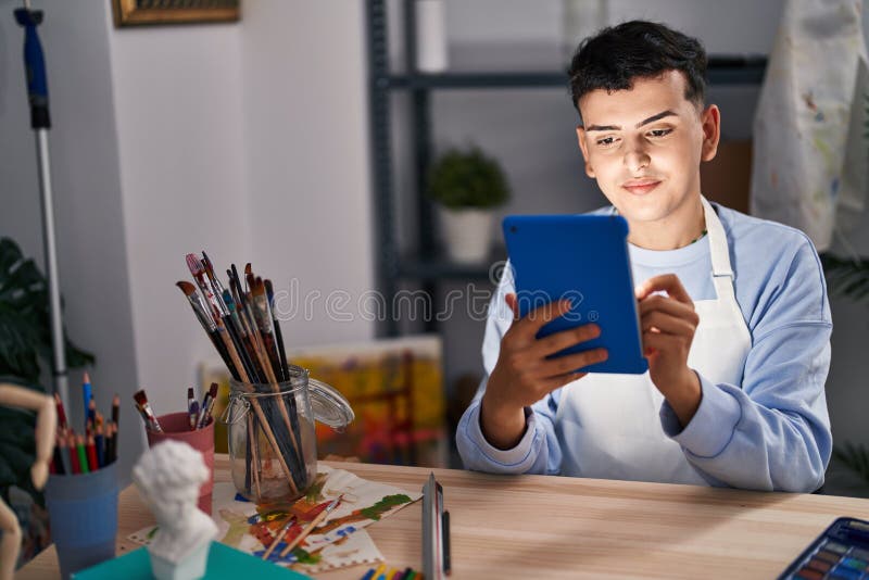 Young Non Binary Man Artist Smiling Confident Drawing on Touchpad at ...