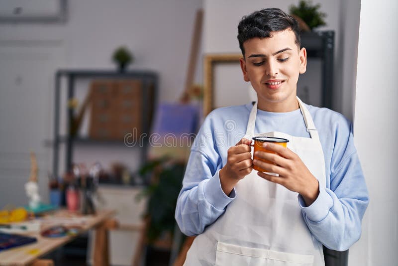 Young Non Binary Man Artist Smiling Confident Drinking Coffee at Art ...