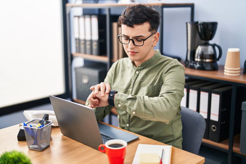 Young Non Binary Man Business Worker Using Laptop Looking Watch at ...