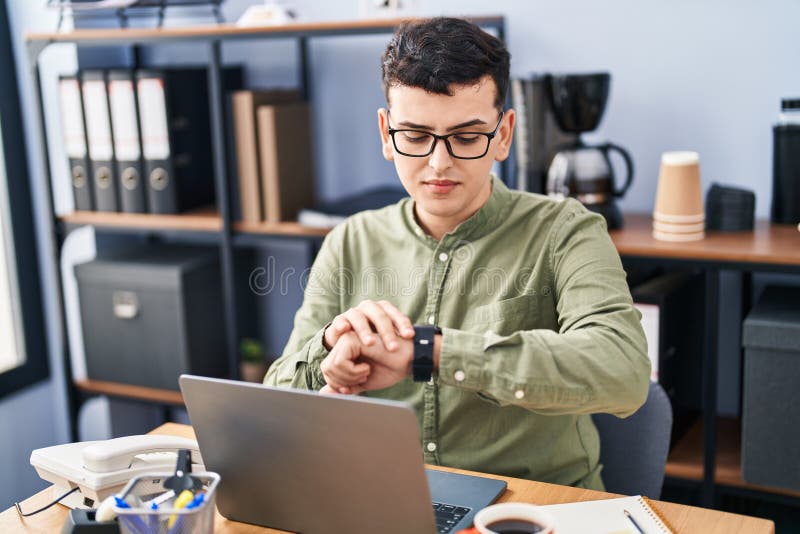 Young Non Binary Man Business Worker Using Laptop Looking Watch at ...