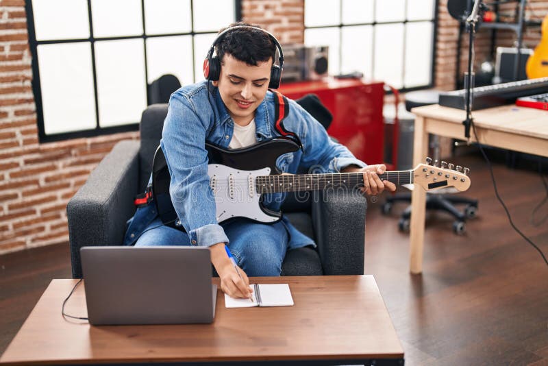 Young Non Binary Man Musician Composing Song Playing Electrical Guitar ...