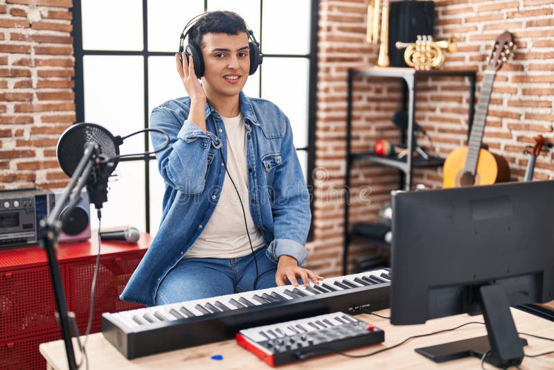 Young Non Binary Man Musician Playing Piano Keyboard at Music Studio ...