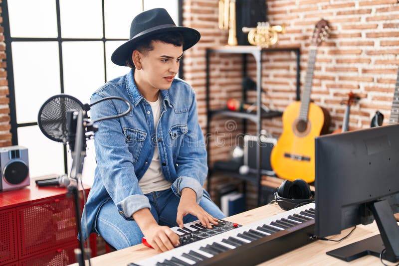 Young Non Binary Man Musician Playing Piano Keyboard at Music Studio ...
