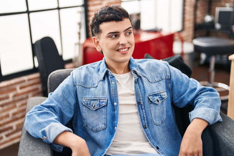 Young Non Binary Man Musician Smiling Confident Sitting on Chair at ...