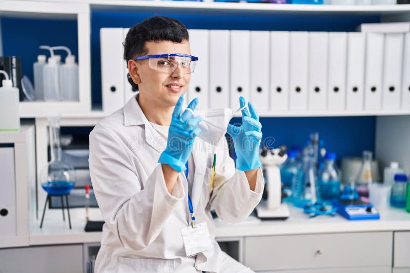 Young Non Binary Man Scientist Smiling Confident Holding Medical Mask ...