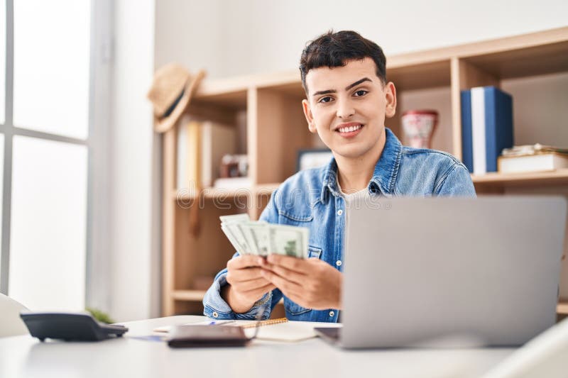 Young Non Binary Man Sitting on Table Counting Dollars at Home Stock ...