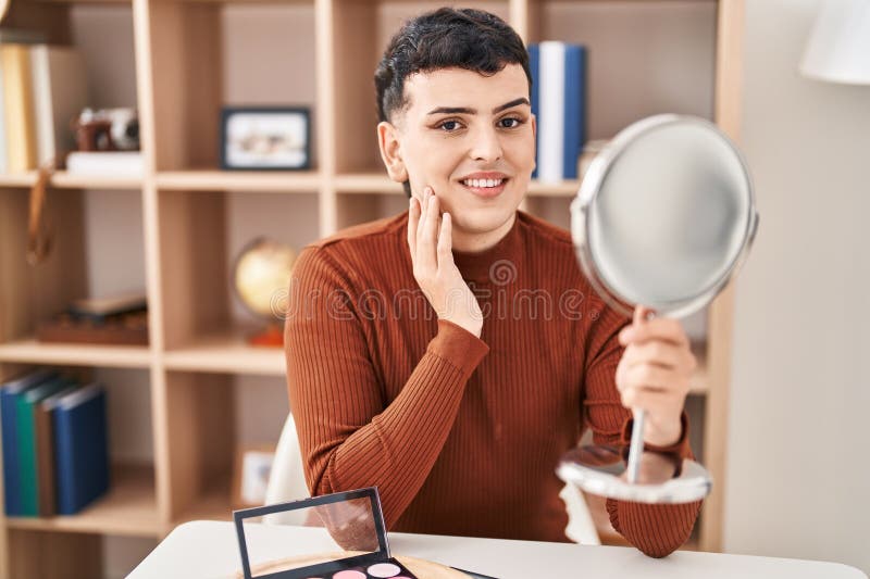 Young Non Binary Man Smiling Confident Looking on Mirror at Home Stock ...