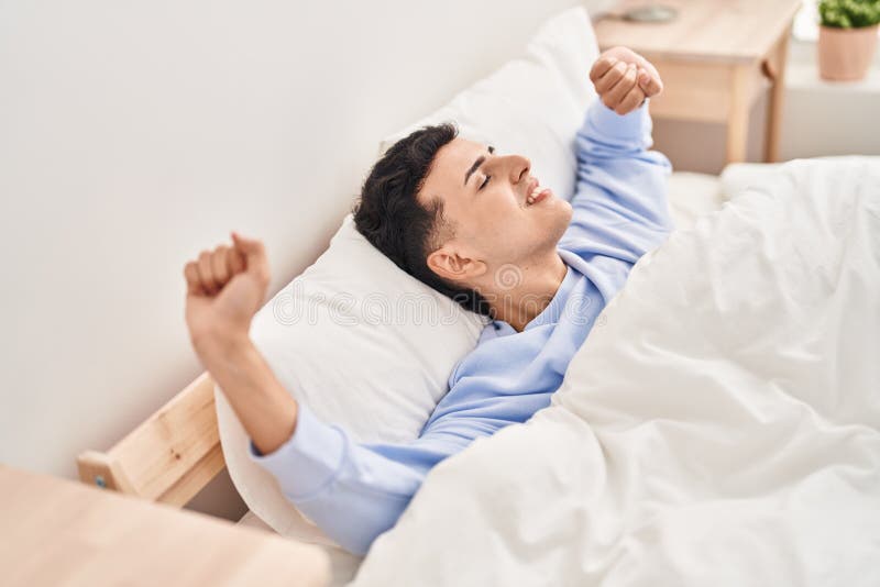 Young Non Binary Man Waking Up Stretching Arms Stock Image - Image of ...