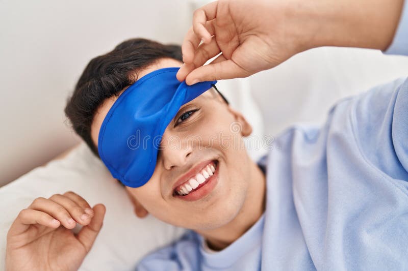 Young Non Binary Man Wearing Sleep Mask Lying on Bed Stock Image ...