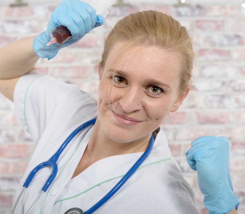 Menacing Nurse Holding Needle Stock Photo - Image of immunization ...