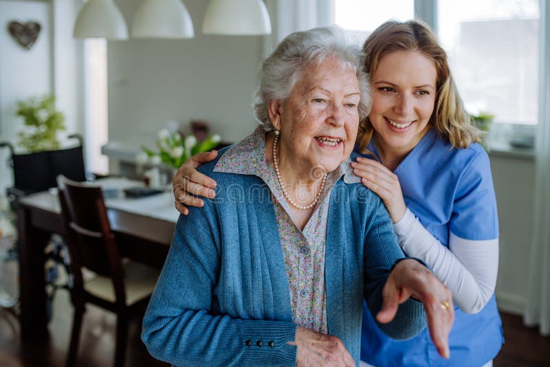 Young Nurse Hugging Her Senior Woman Client. Stock Image - Image of ...