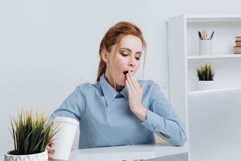 Young Office Girl Sitting at Her Workplace Feeling Sleepy. Stock Image ...