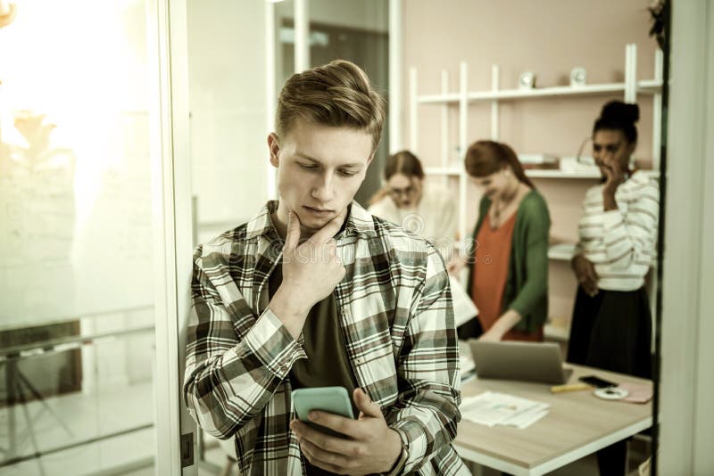 Young Office Trainee Using His Phone during Break from Work Stock Photo ...