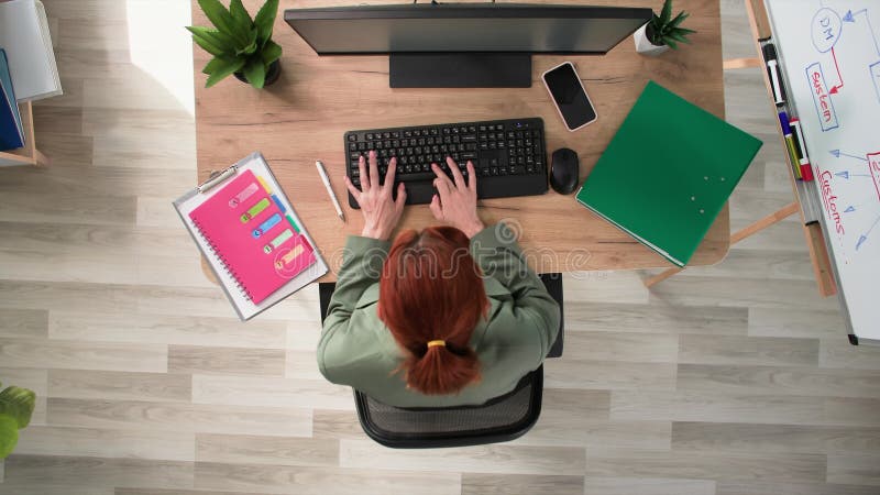 Young Office Woman Working at a Computer and Typing on a Keyboard while ...