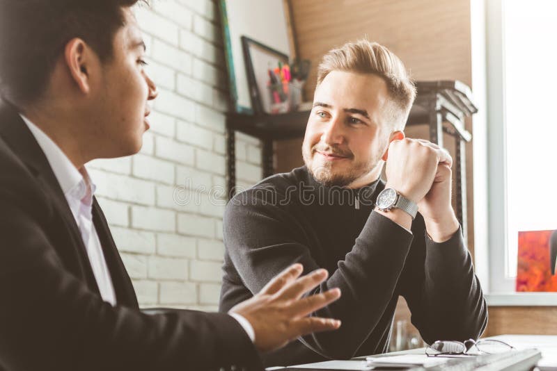 Young Office Worker Sitting at Desk, Using Computer. Two Business Man ...