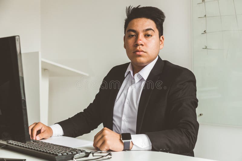 Young Office Worker Sitting at Desk, Using Computer. Two Business Man ...