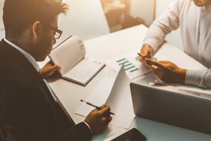 Young Office Worker Sitting at Desk, Using Computer. Two Business Man ...