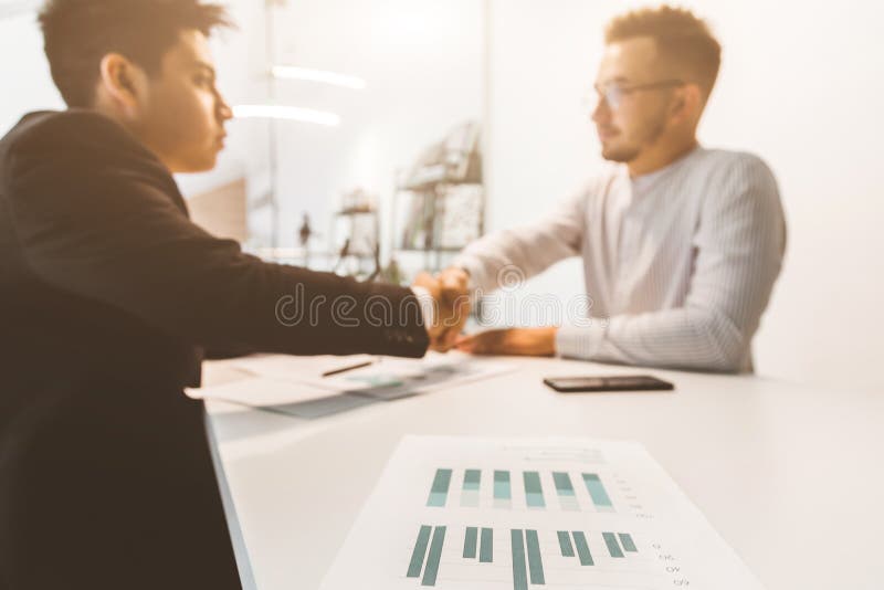 Young Office Worker Sitting at Desk, Using Computer. Two Business Man ...