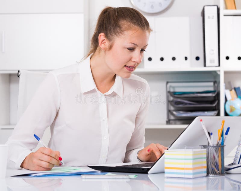 Young Office Worker is Working with Documents and Laptop Stock Image ...