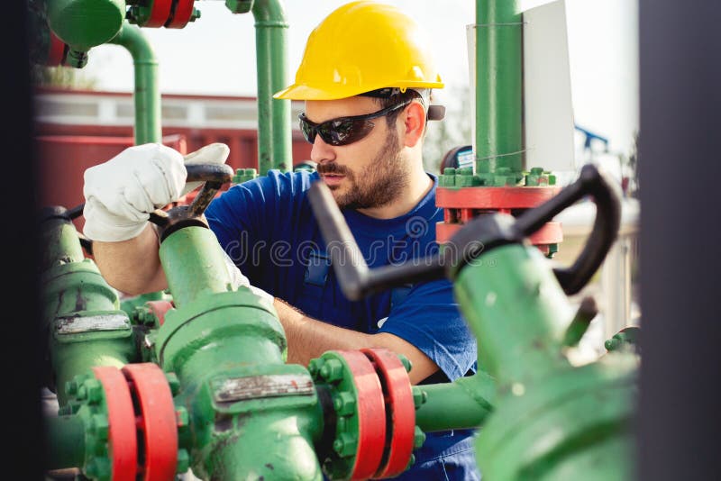 Oil Worker Turning Valve on Oil Rig Stock Photo - Image of hardhat ...