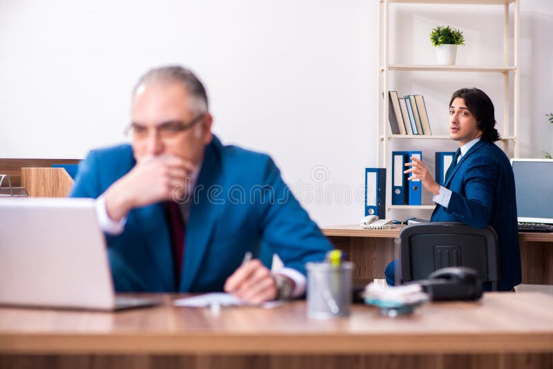 The Young and Old Employees Working Together in the Office Stock Image ...