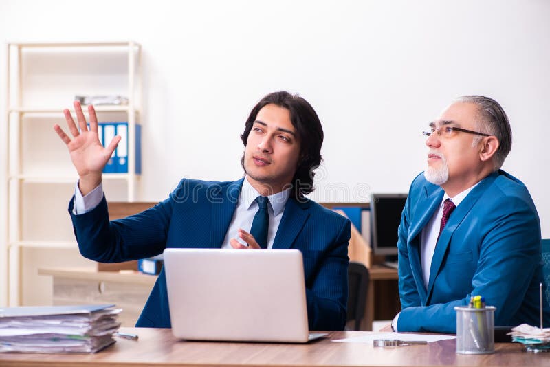 The Young and Old Employees Working Together in the Office Stock Photo ...