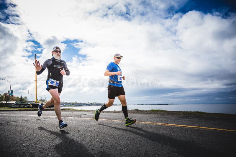 Senior Man Running Alone during the Marathon with Beautiful Ocean ...