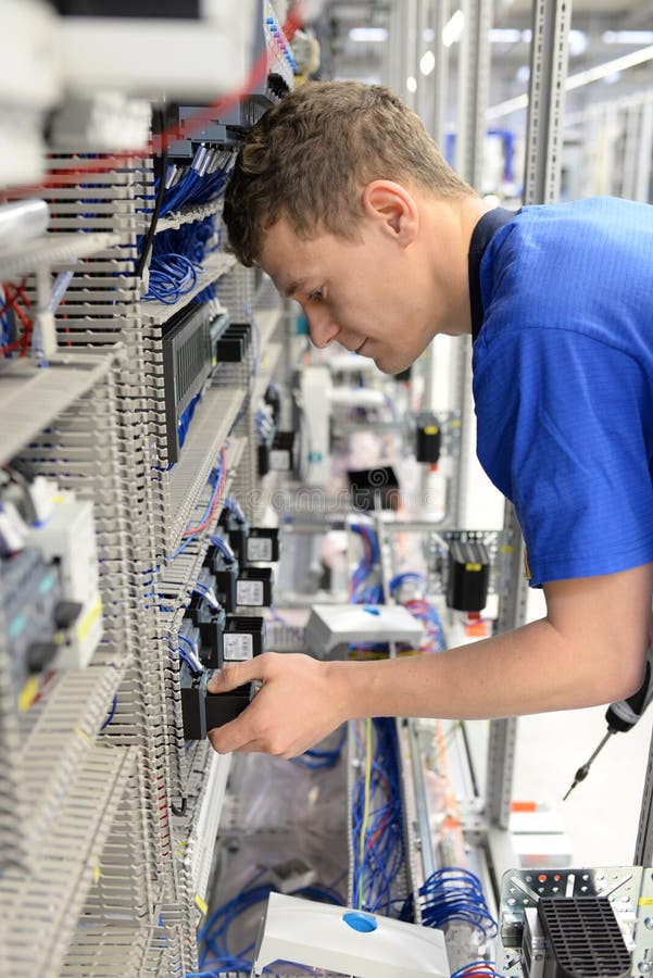Young Operator Assembles Machine in a Modern High Tech Factory ...