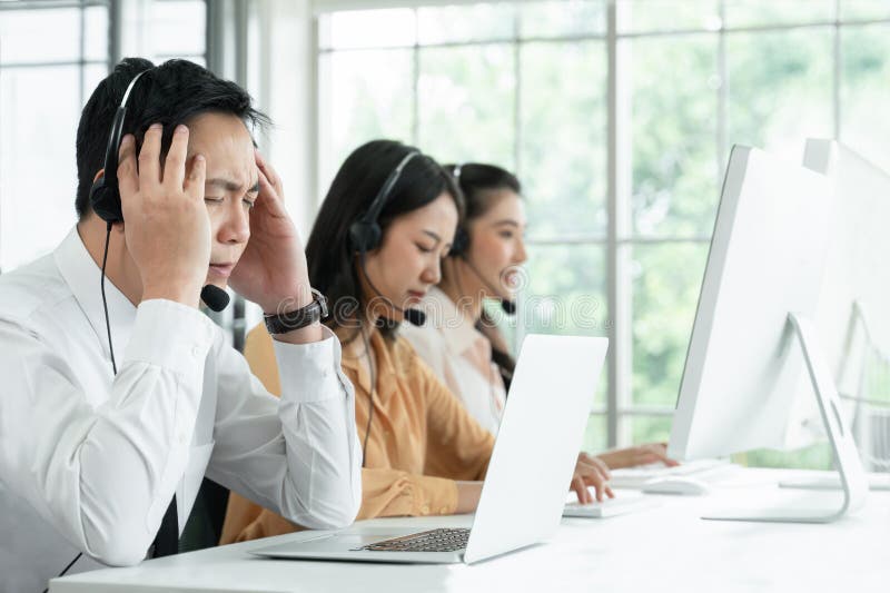 Young Operator Man Headache while Working with Headset Doing Customer ...