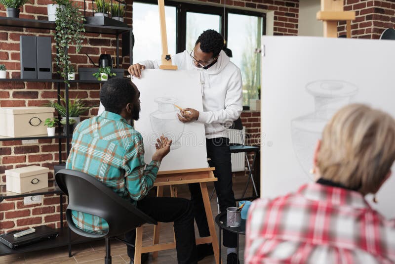 Young Painter Teacher Helping Student with Drawing Process during Art ...