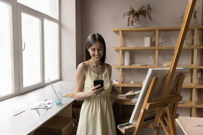 Young Painter Woman Using Cellphone Standing in Art Studio Stock Photo ...