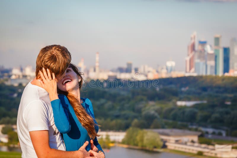 Young Pair on a Background of Blue Sky Stock Photo - Image of buildings ...