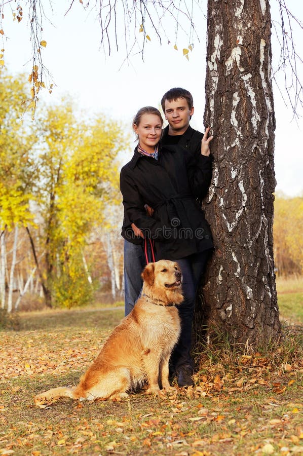 Young pair with dog stock image. Image of tree, animal - 23665789