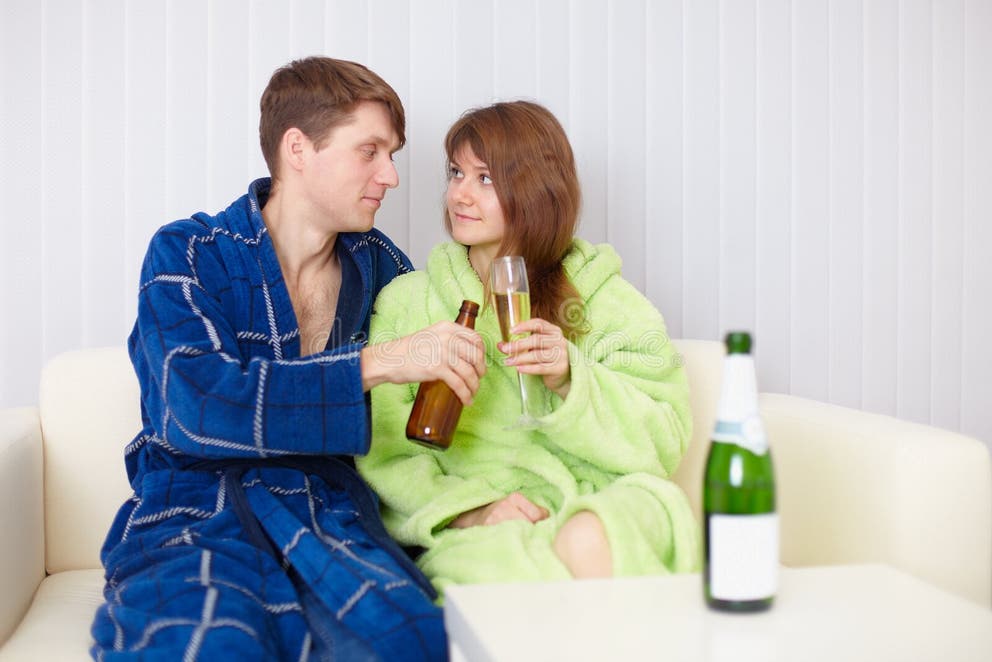 Young Pair at Home on Divan with Beer and Wine Stock Image - Image of ...